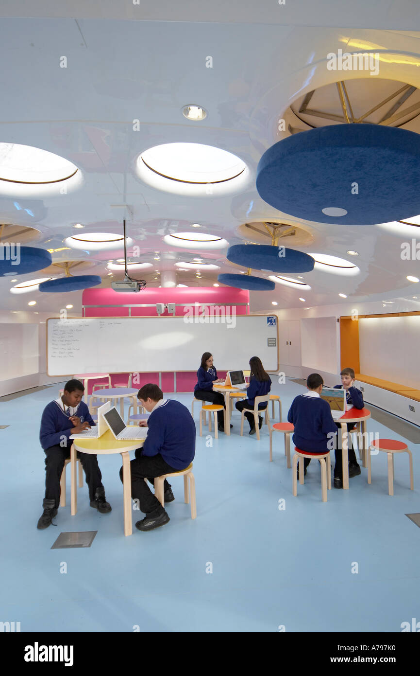Schoolboy and schoolgirl children pupils in modern classroom of the ...