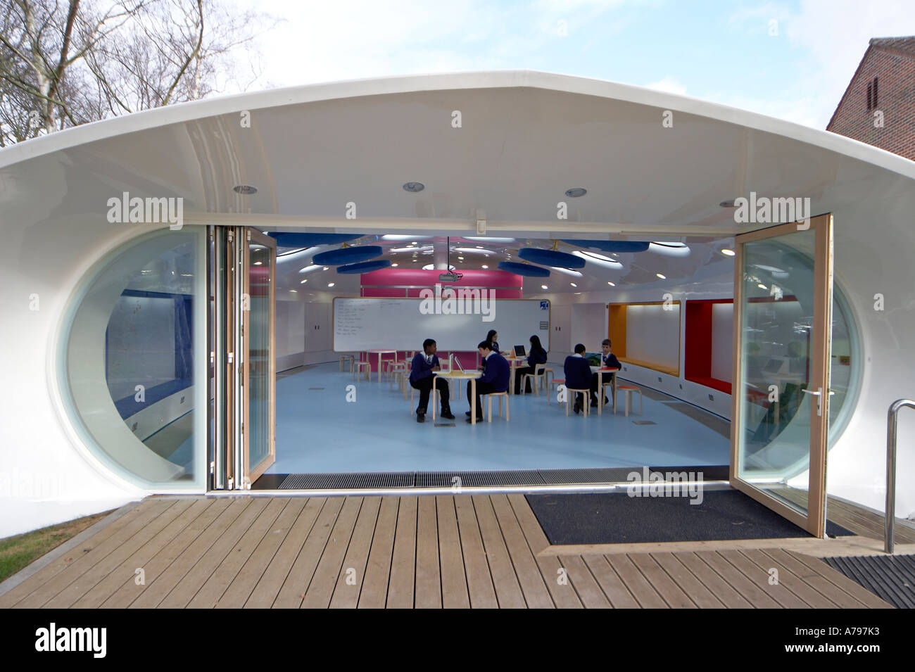 Schoolboy and schoolgirl children pupils in modern classroom of the ...