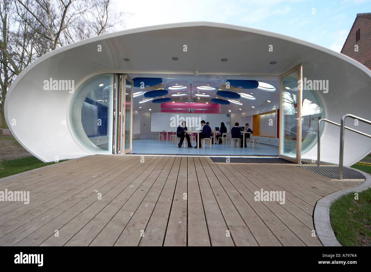 Schoolboy and schoolgirl children pupils in modern classroom of the ...
