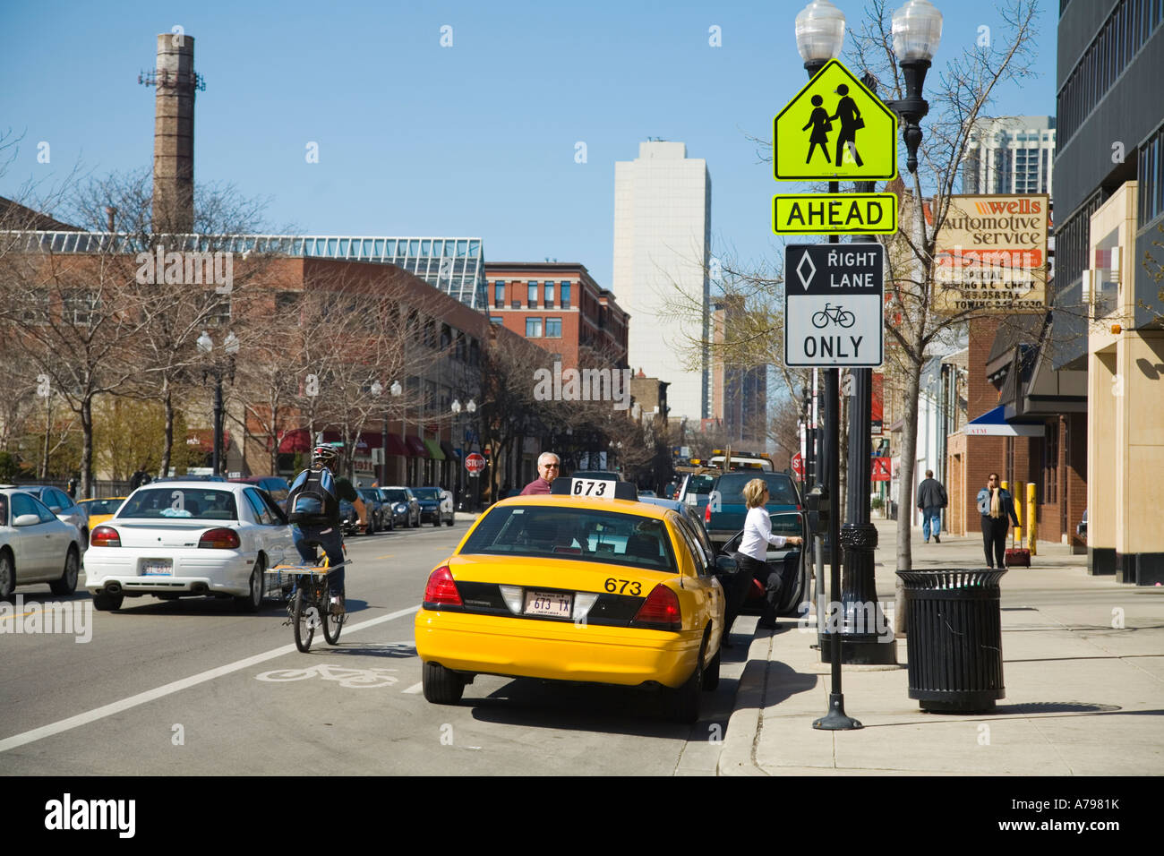 CHICAGO Illinois Bicyclist in designated bike lane street sign on post ...
