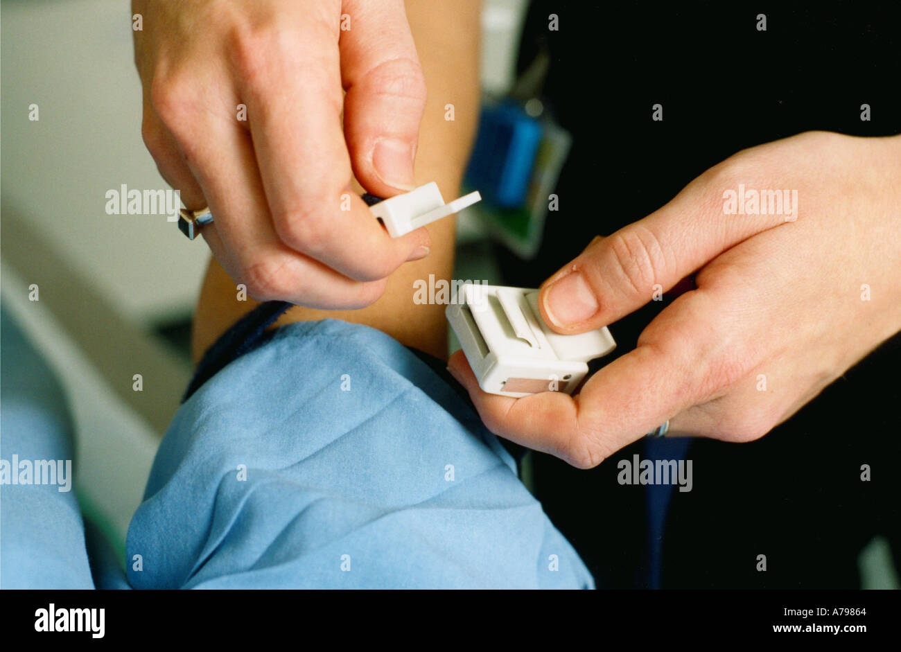 Applying tourniquet for venepuncture Stock Photo - Alamy