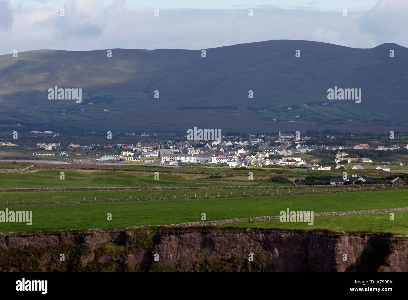 Town of Waterville with dark mountain backdrop on Ring of Kerry in ...
