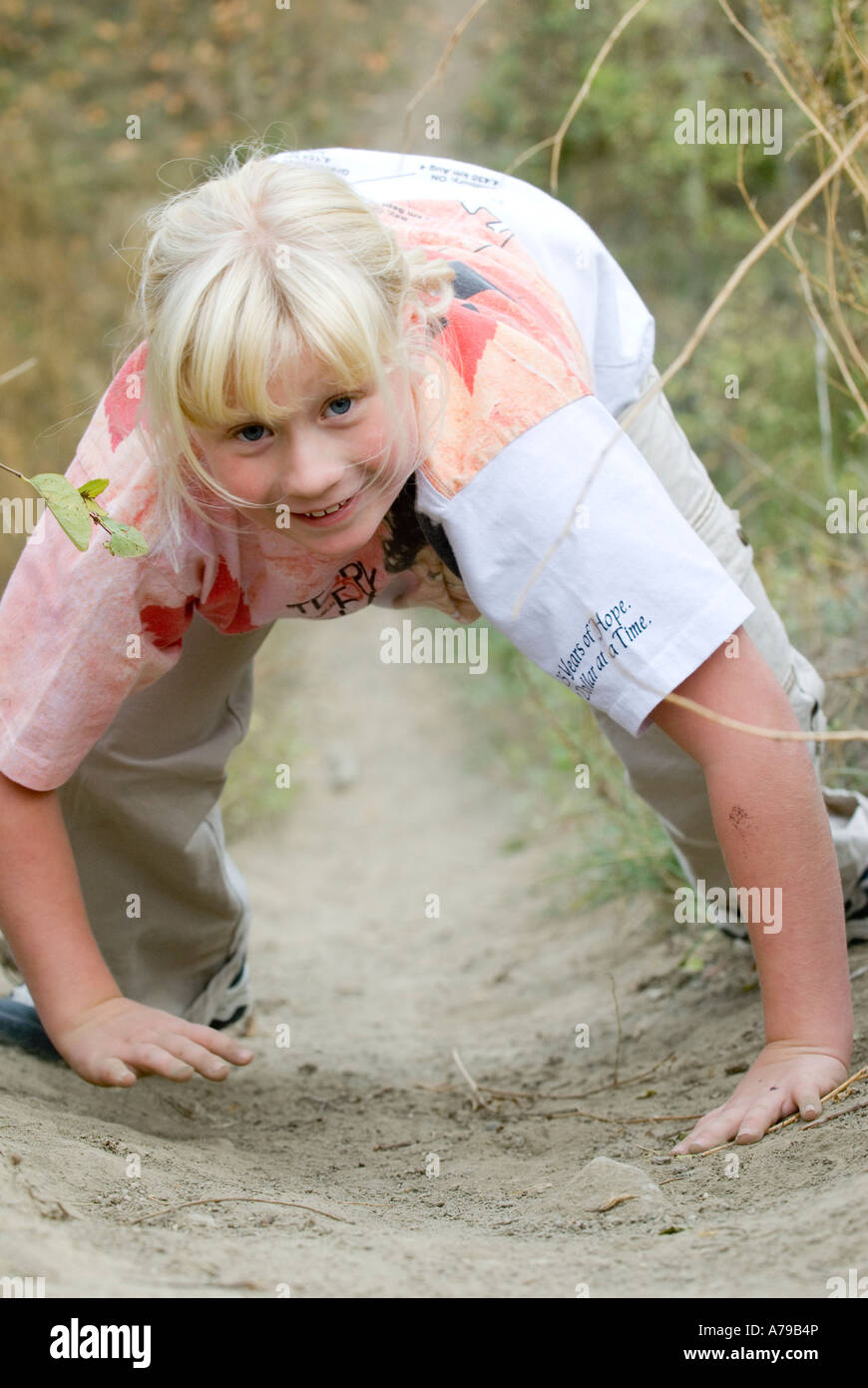 A young girl climbing up a steep path on the River Trail in Williams ...