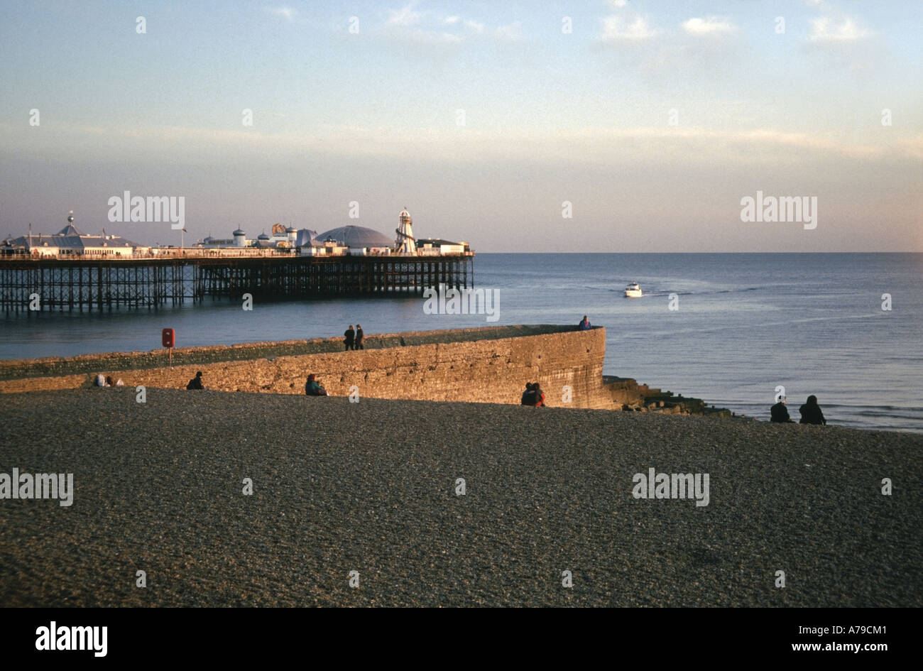 Couples on Brighton Beach at sunset in winter England UK Stock Photo ...