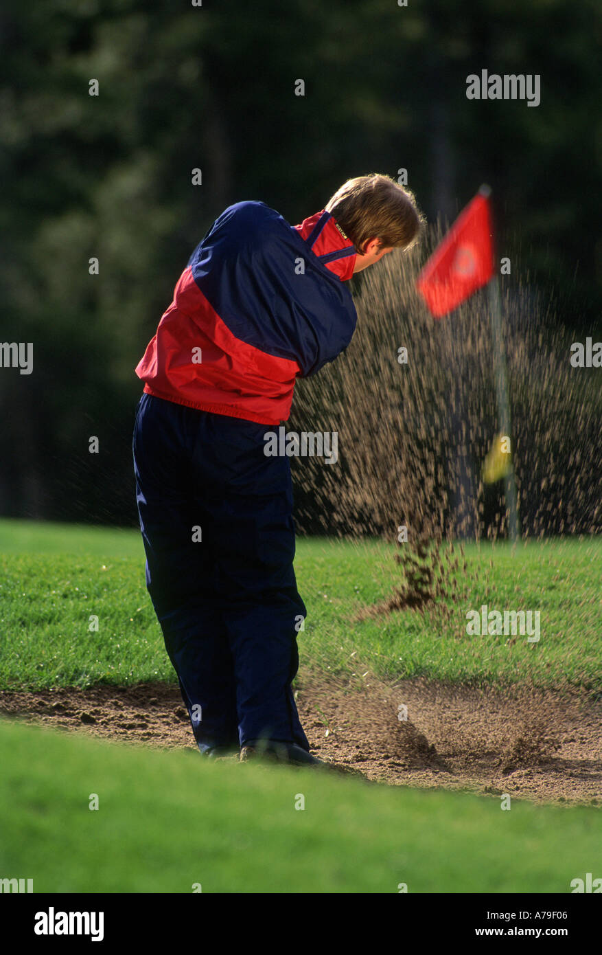 Male golfer chipping ball from the sand Stock Photo - Alamy