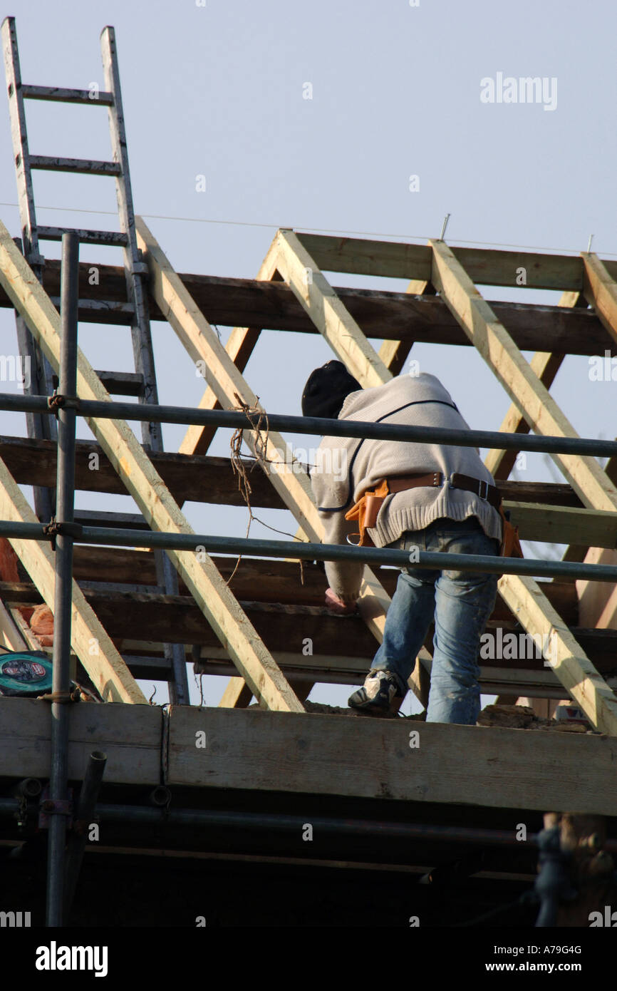 Workers roofing a barn during the winter wearing warm clothing Stock ...