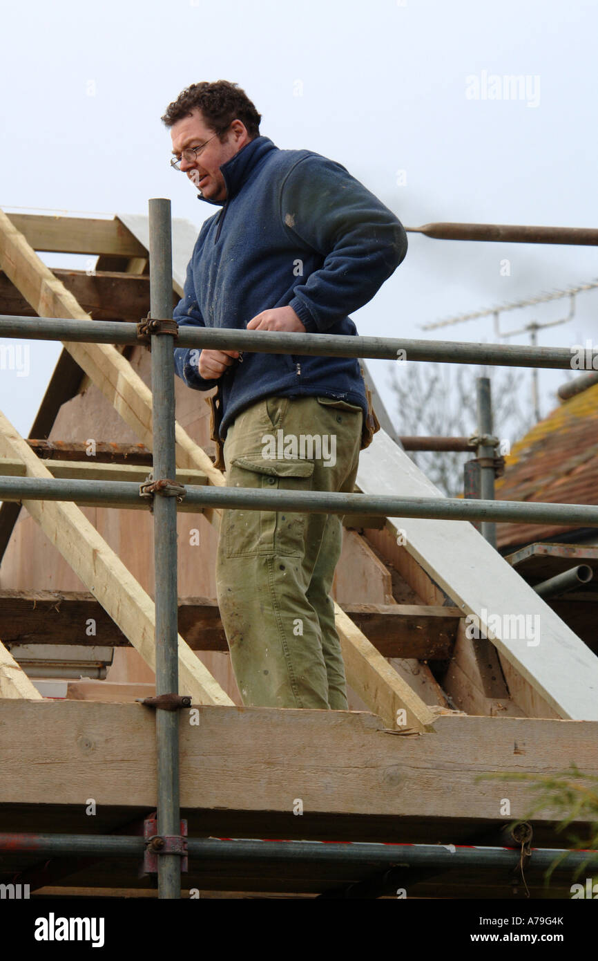 Workers roofing a barn during the winter wearing warm clothing Stock ...
