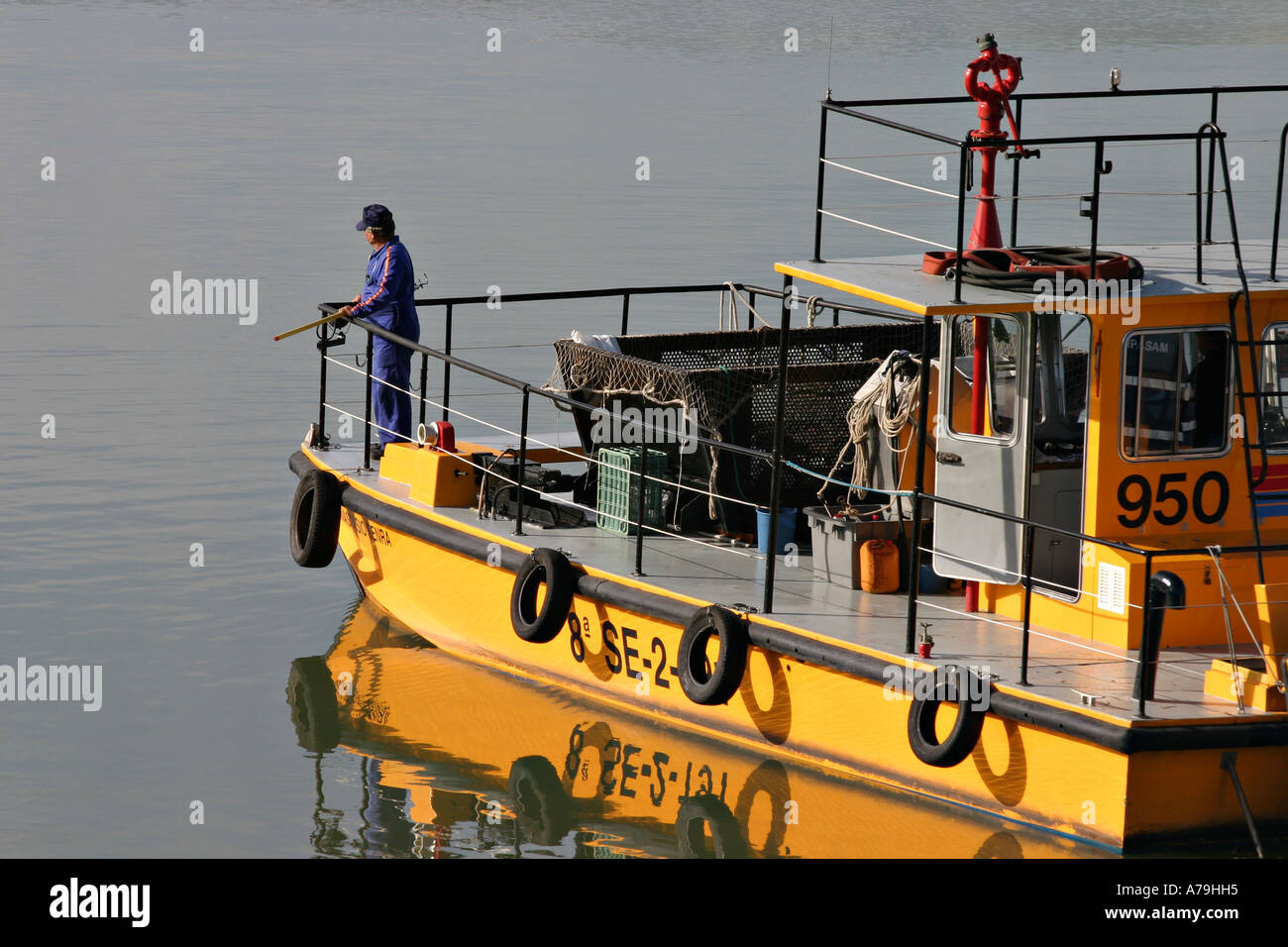 On Patrol: City maintenance boat on the canal river in downtown Seville ...