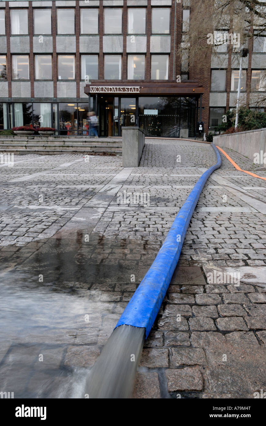 Pipe used for pumping water from building after flood Stock Photo - Alamy