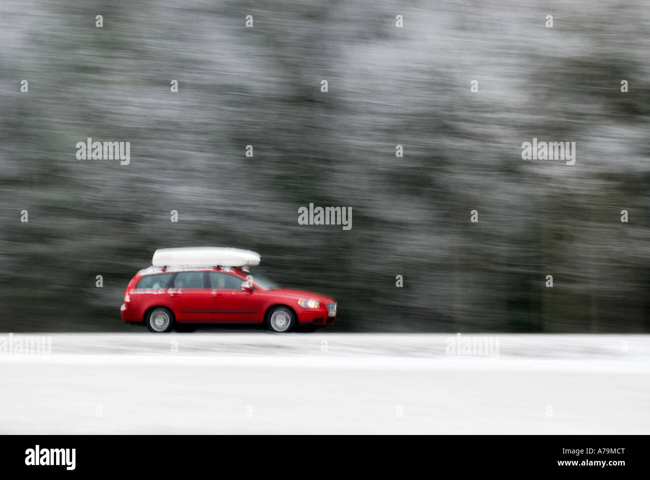 Red car driving on road in winter, Sweden Stock Photo - Alamy