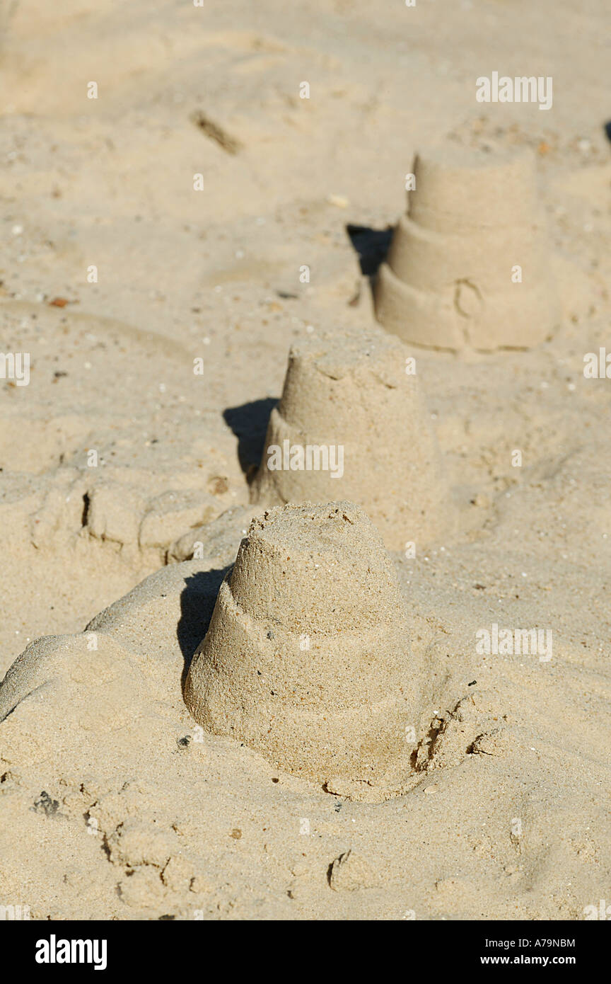 A line of three sand castles built on the beach Stock Photo - Alamy