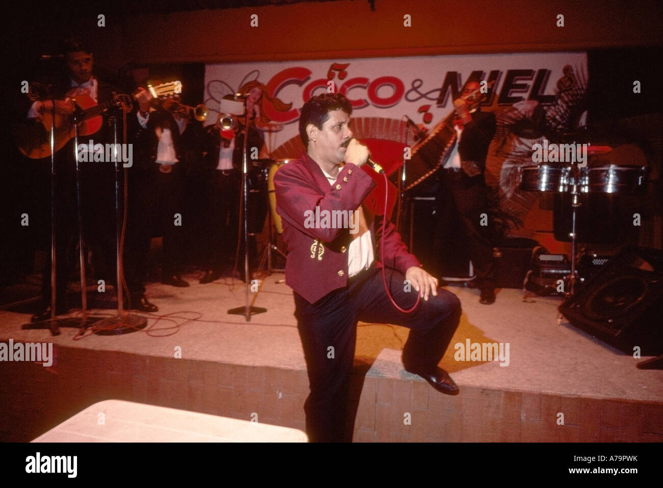 Mariachi singer performing with his band in a club in Cartagena ...