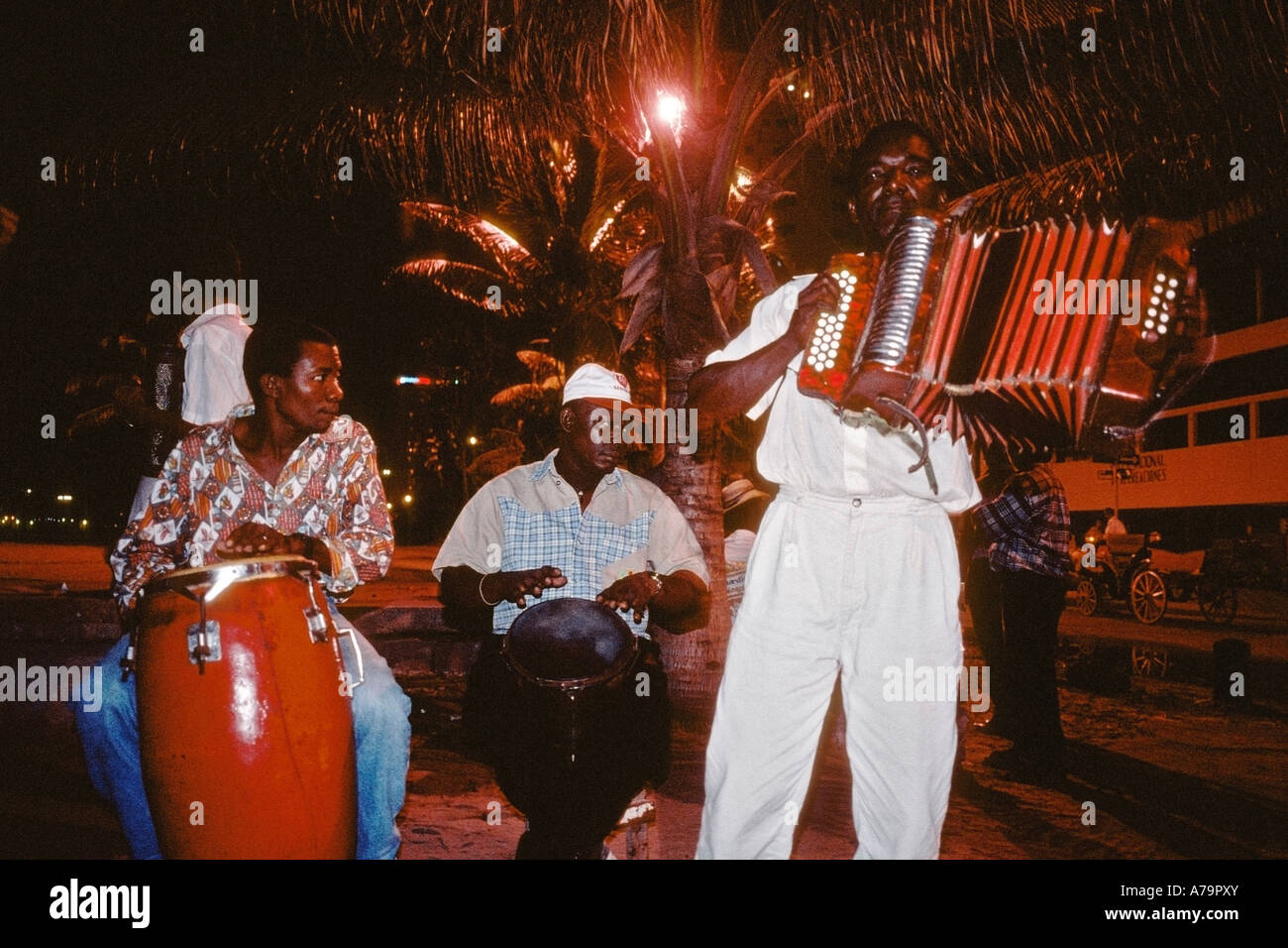 Musical group playing cumbia on the street at night in Cartagena ...