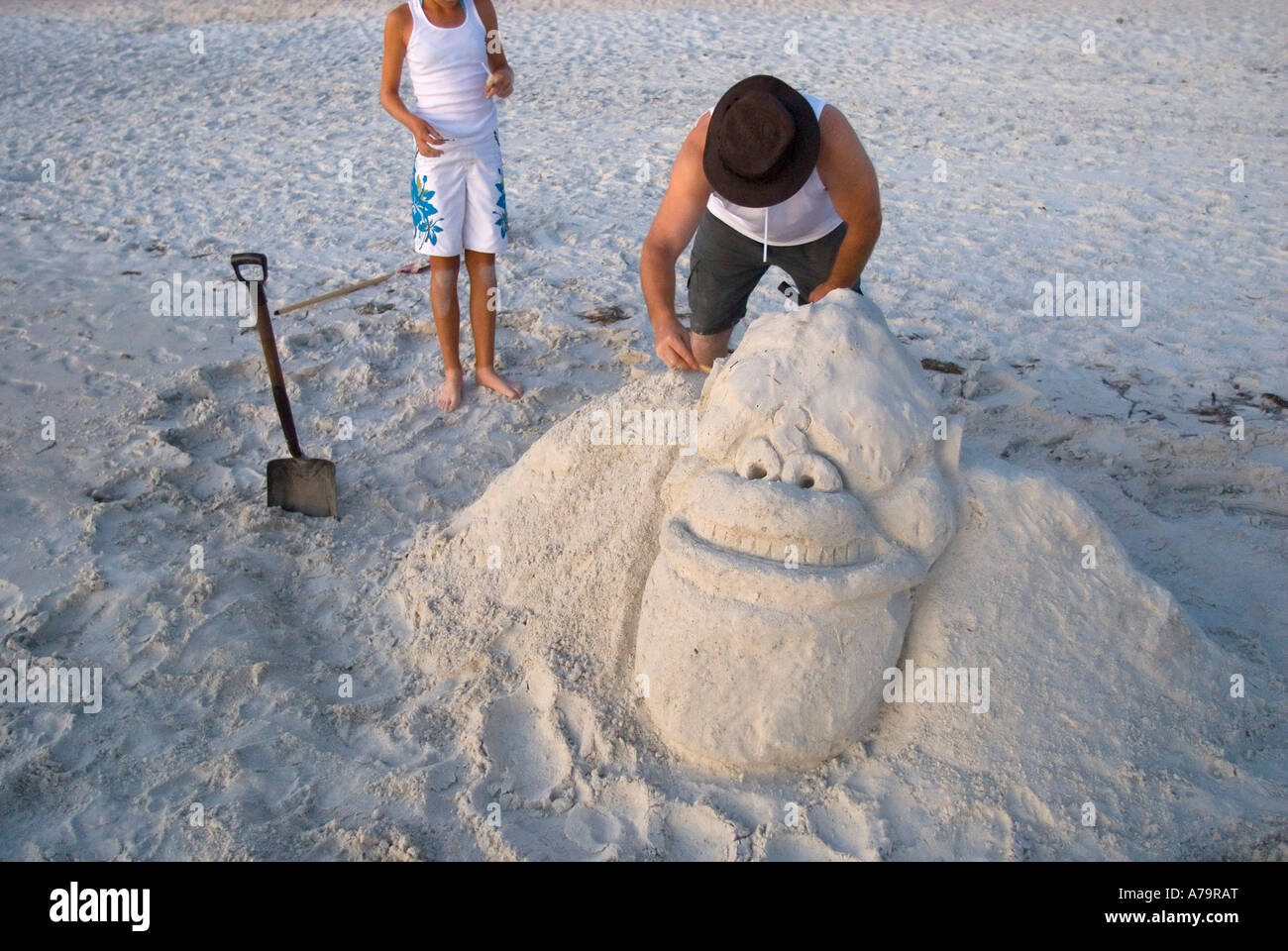 Father and daughter creating a sand sculpture on the beach at Anna ...