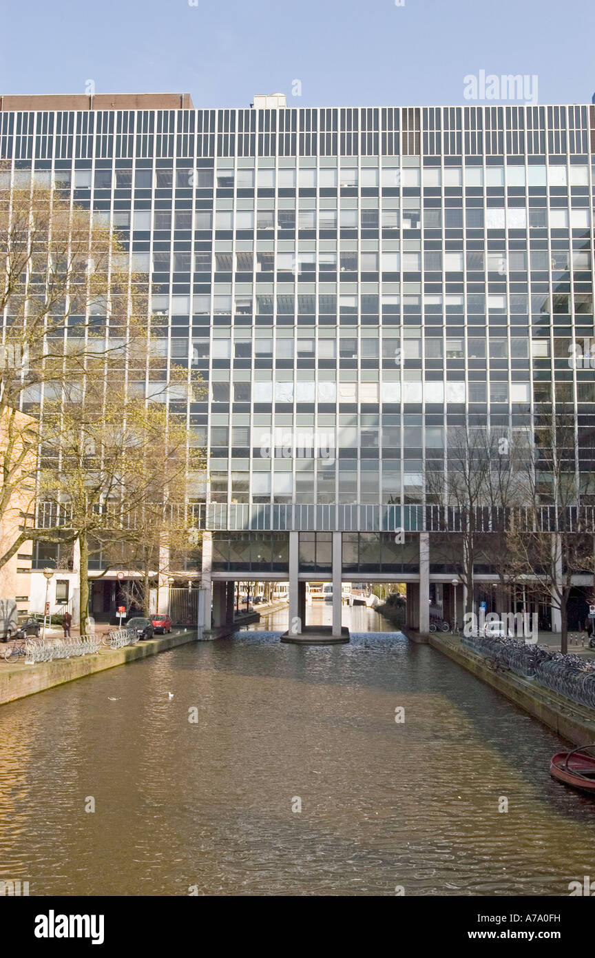 Modern building of Amsterdam University with water canal pass, Holland ...