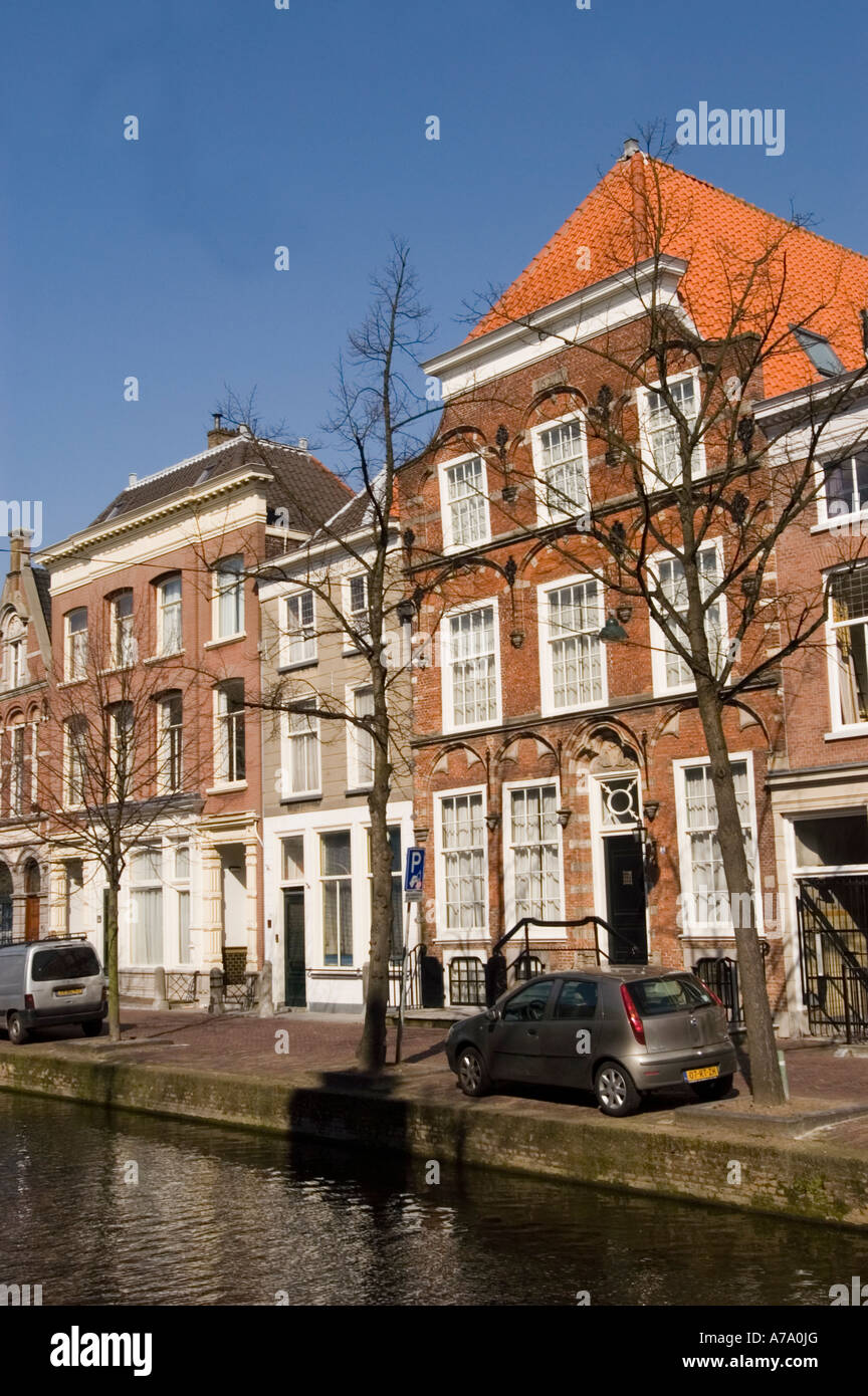 Old canal in Delft with row of heritage buildings and blue sky South ...