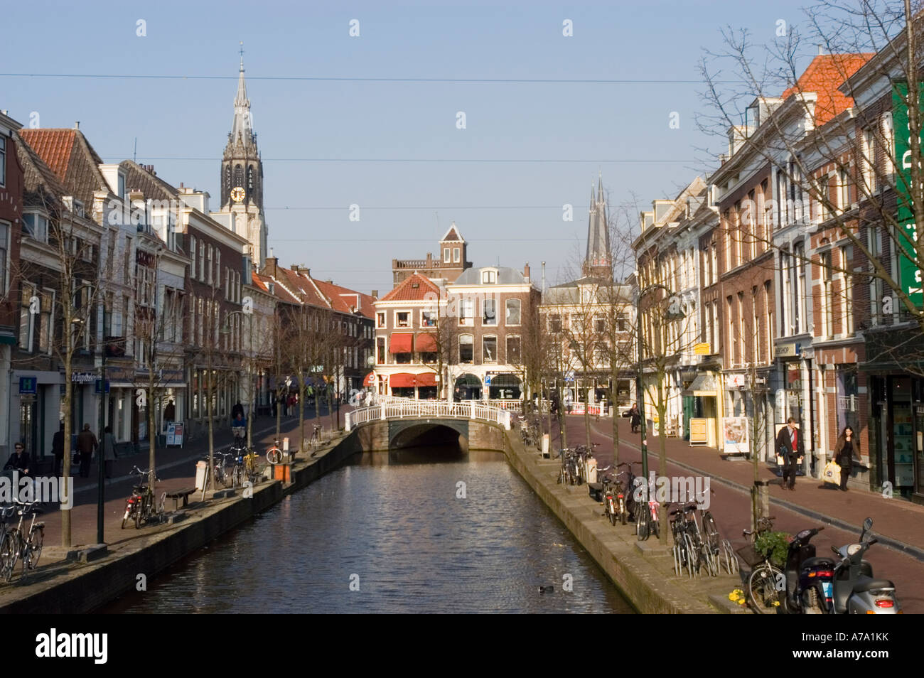 small bridge over canal gracht in Delft with blue sky and Old Church ...