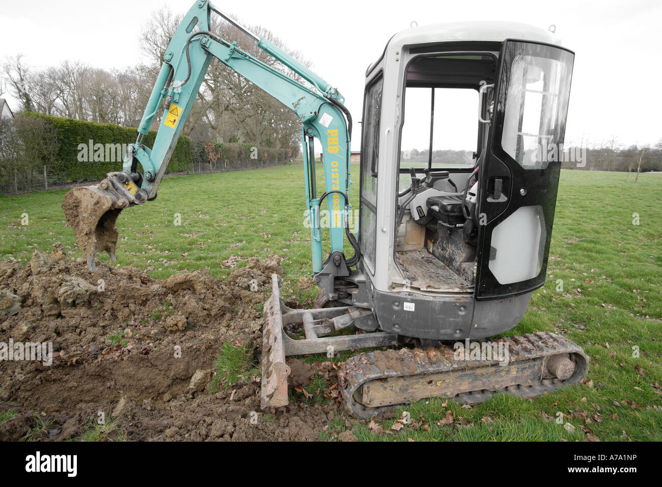 Mechanical digger with caterpillar tracks Stock Photo - Alamy