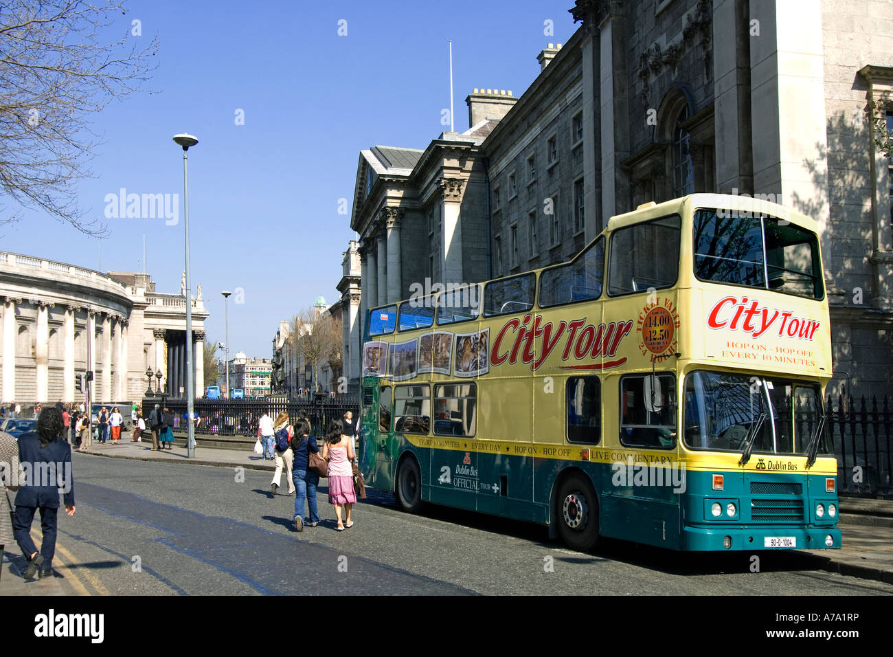 An open-topped tour bus outside Trinity College in Dublin, Ireland ...