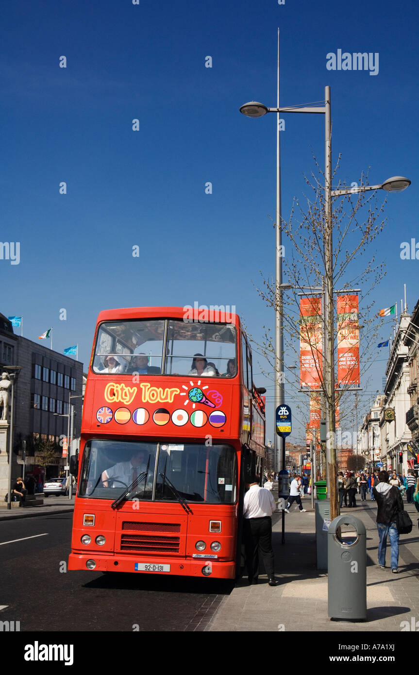 An open-topped tour bus on O'Connell Street with the Spire in the ...