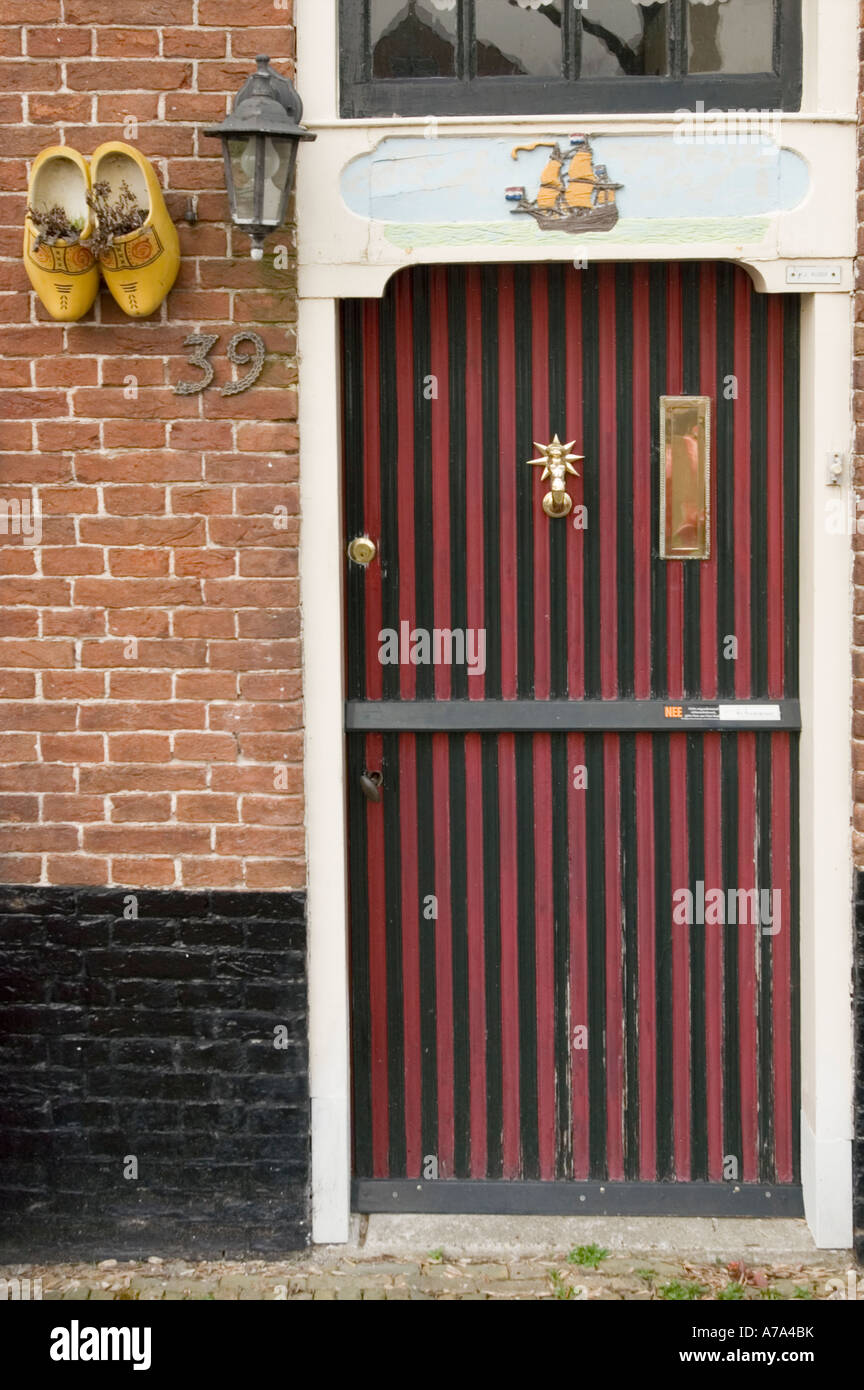 Entrance to small typical Dutch brick house in Edam with wooden shoes ...
