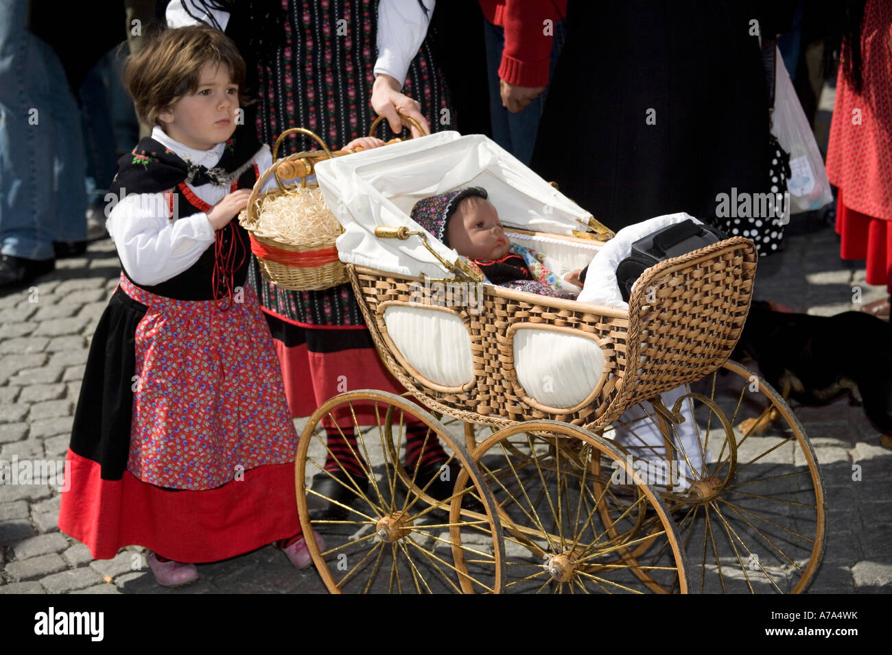 Little girl pushing an antique pram at the Pasquali Easter parade ...