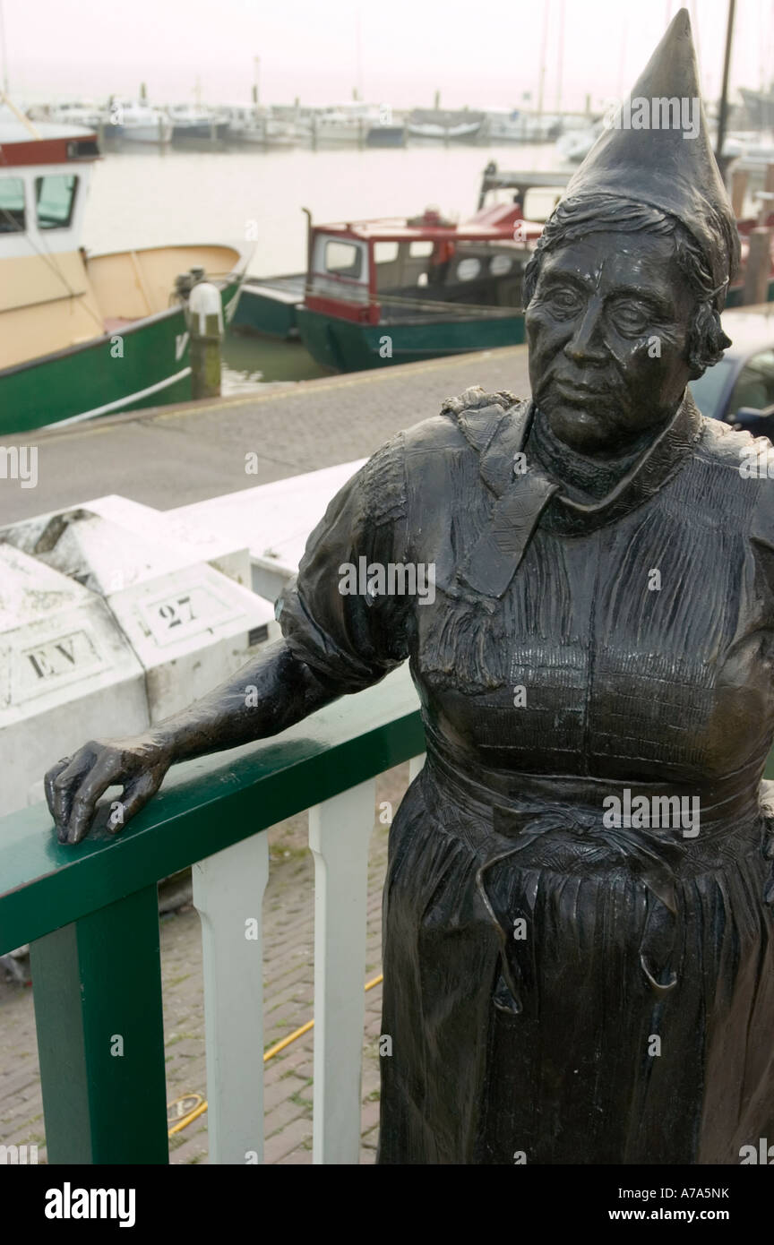 Metal statue of Dutch woman in Volendam port North Holland Stock Photo ...