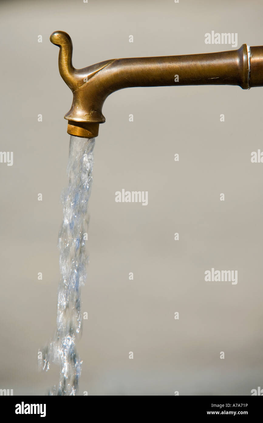 Fountain pouring water Stock Photo - Alamy