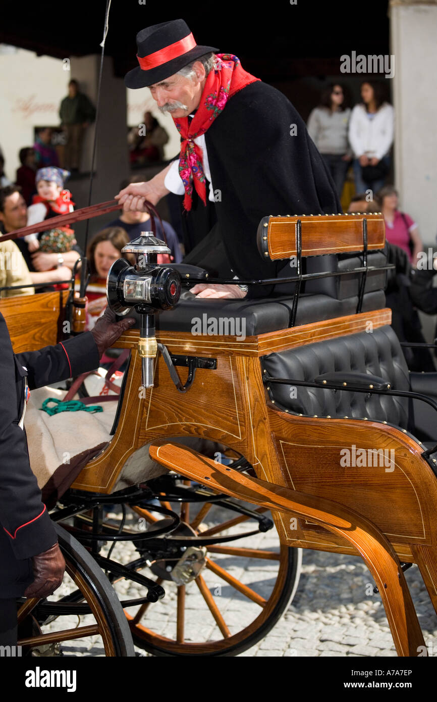 Senior man driving an old wooden carriage, Bormio Easter parade, Italy ...