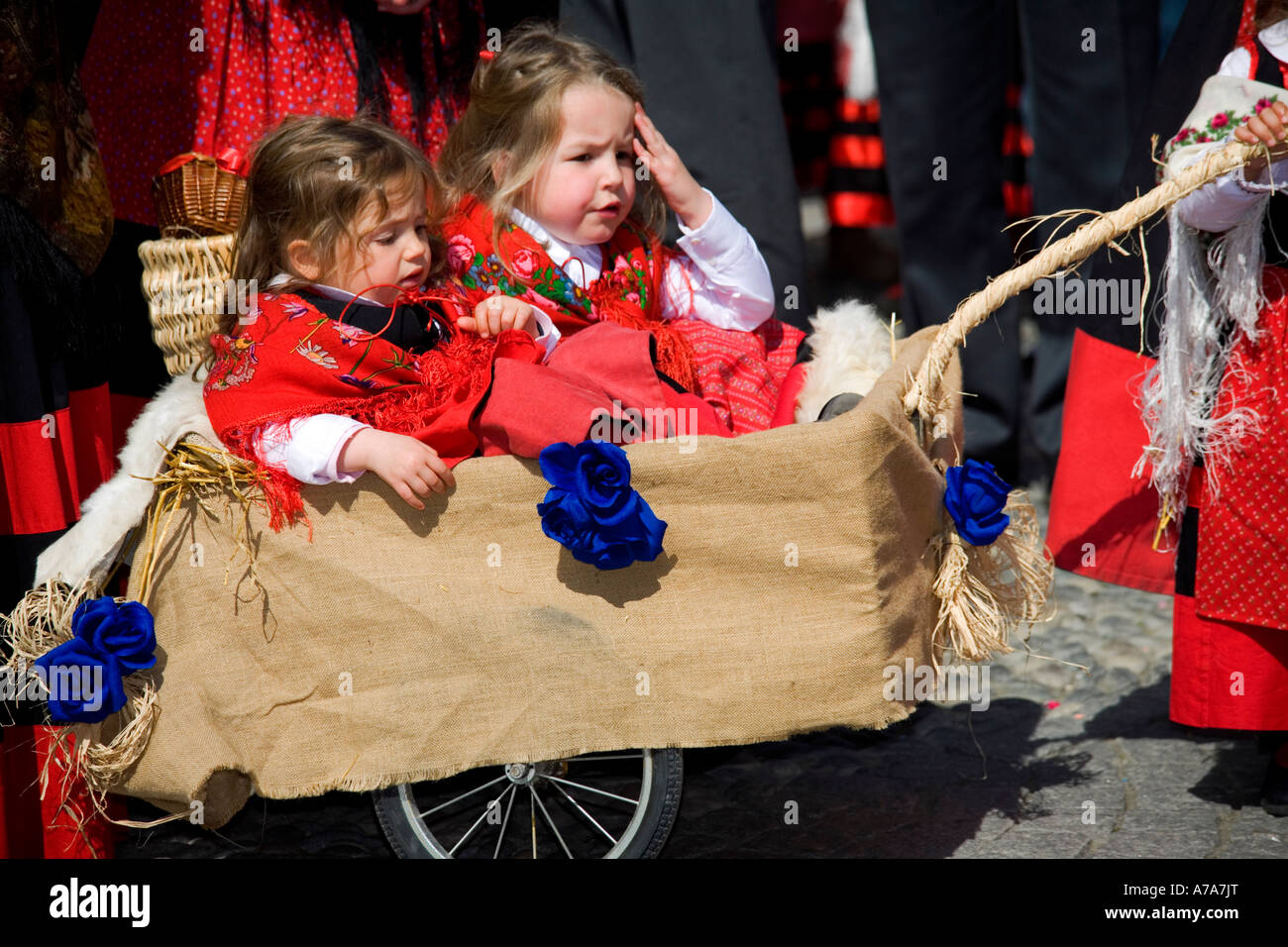 Cute little girls being carried in a little trolley, Bormio Easter ...