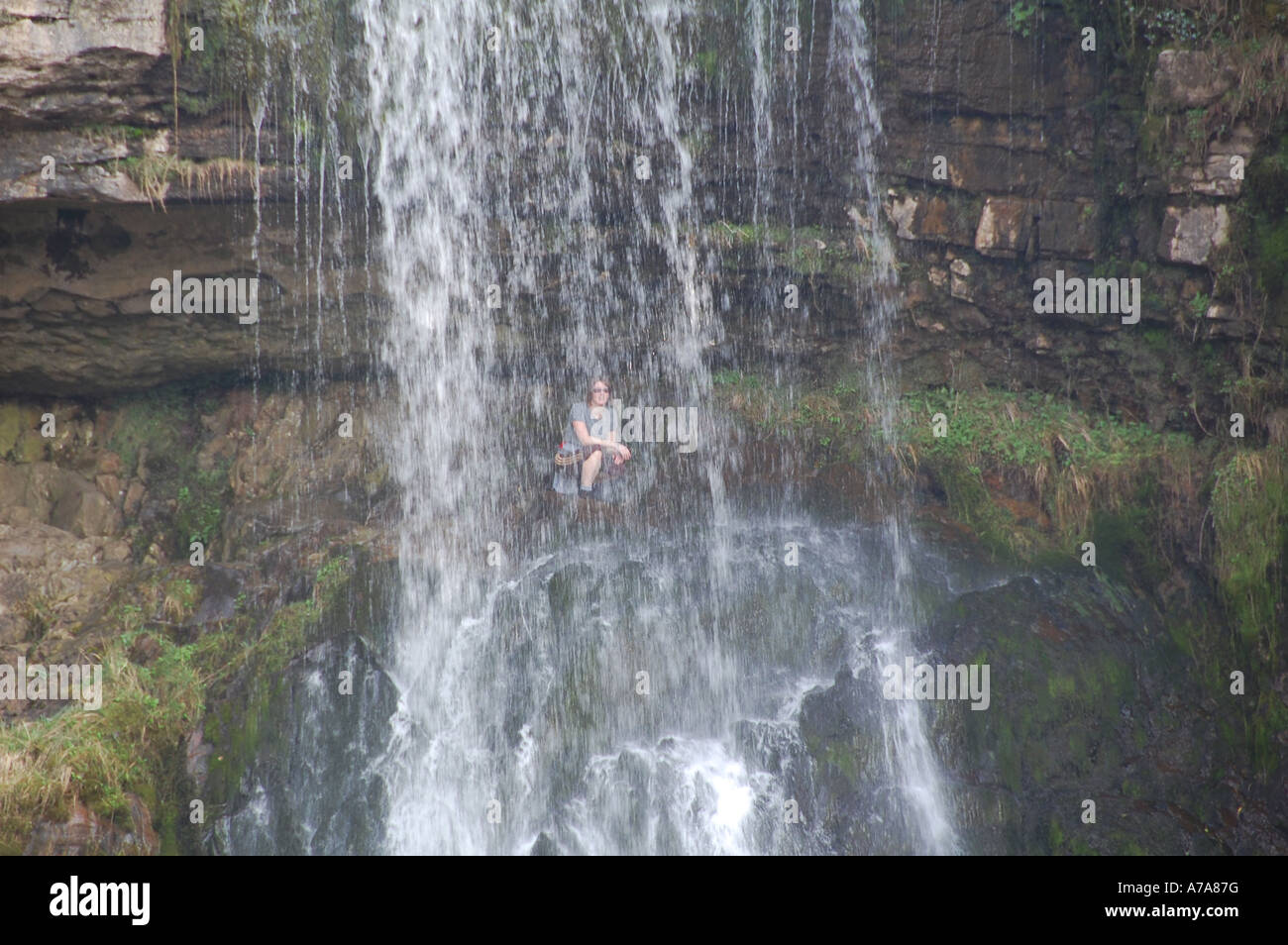 Young woman cooling down behind the Waterfall on the Ingleton ...