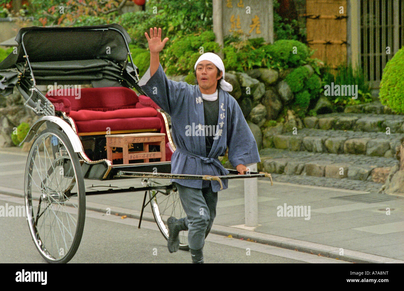 Man running rickshaw in Japanese city Stock Photo - Alamy