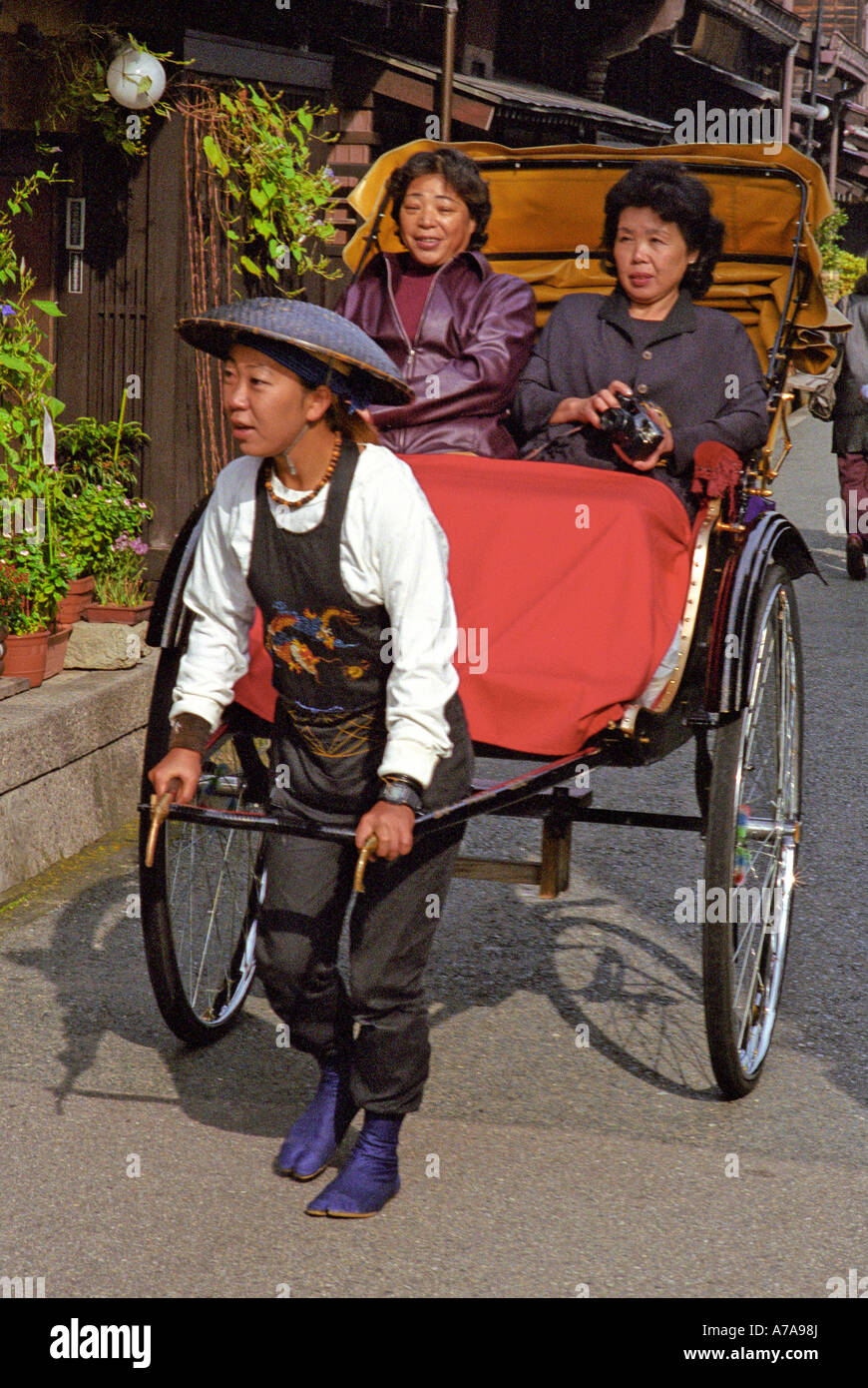Woman Rickshaw Driver and passengers Stock Photo - Alamy