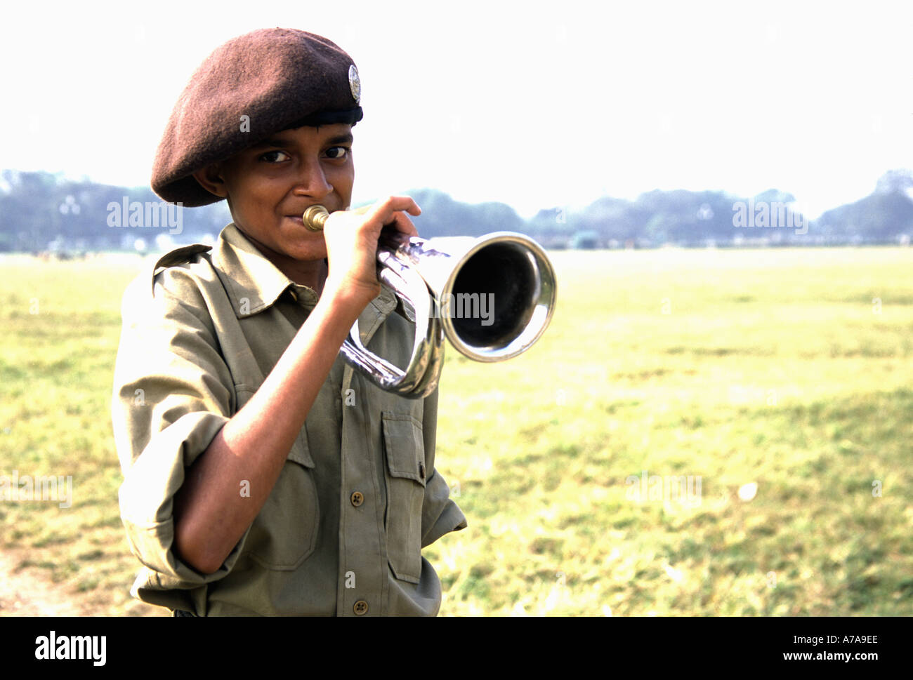 Soldier boy playing a bugle on the Maidan in Calcutta West Bengal India ...