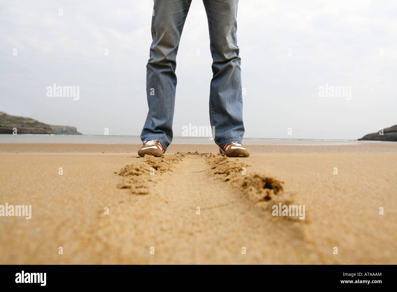 Low view point of male legs standing on both sides of a line drawn in ...