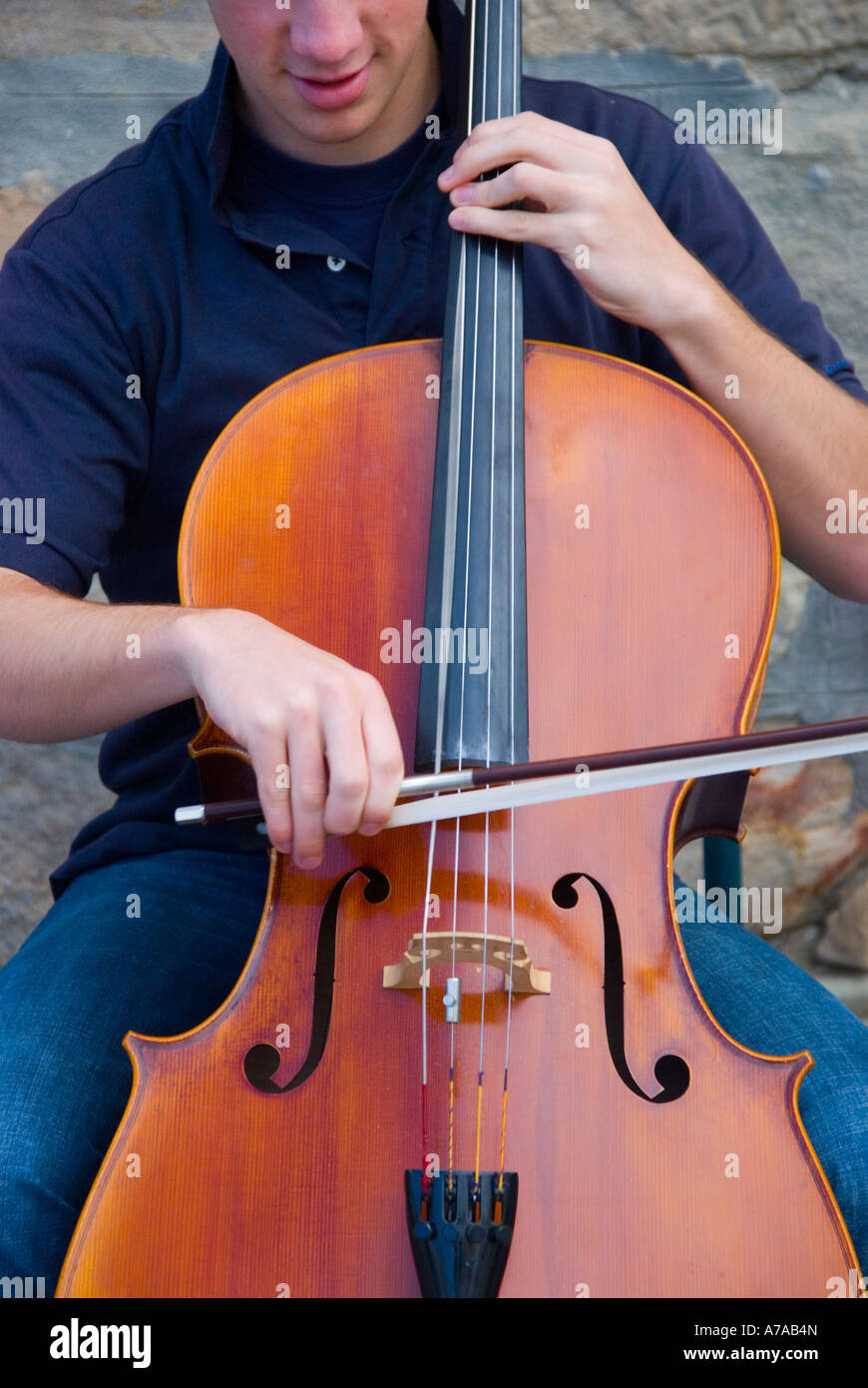 A young classical music student busking by playing the cello in Hobart ...