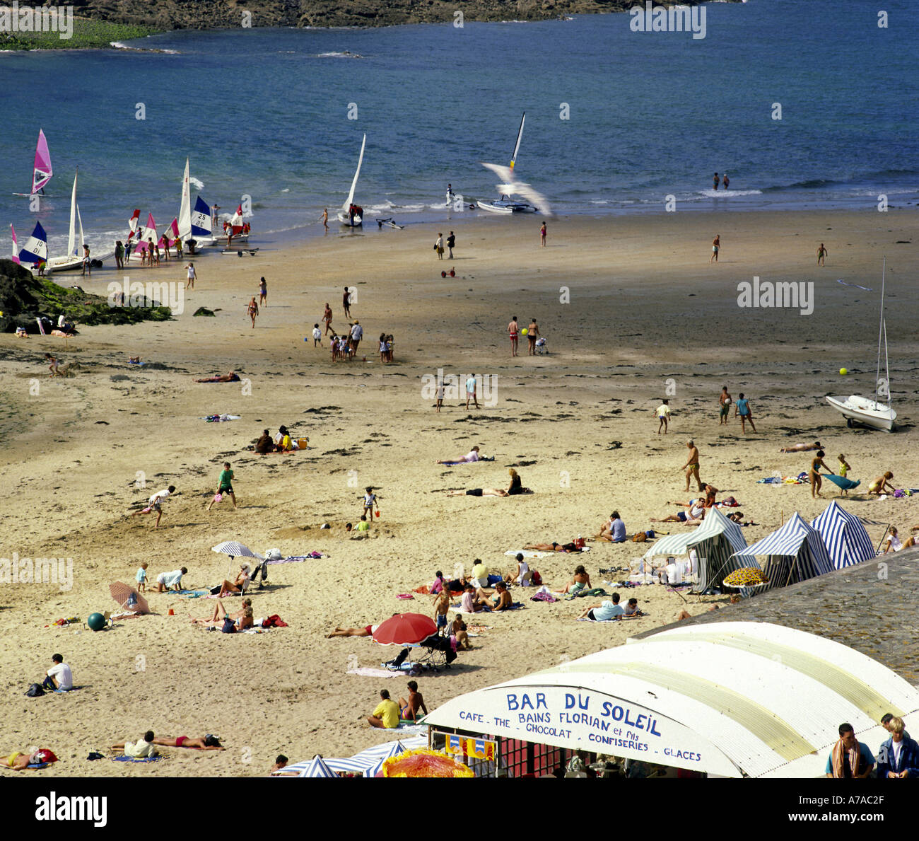 Holiday beach with sunbathers and sail boats Saint Malo Brittany France ...