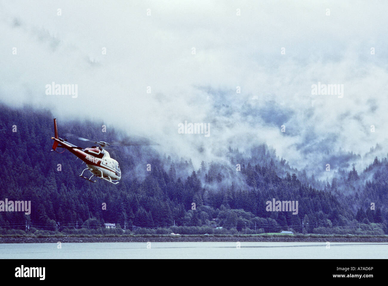 Helicopter Coming into Land over Water Stock Photo - Alamy