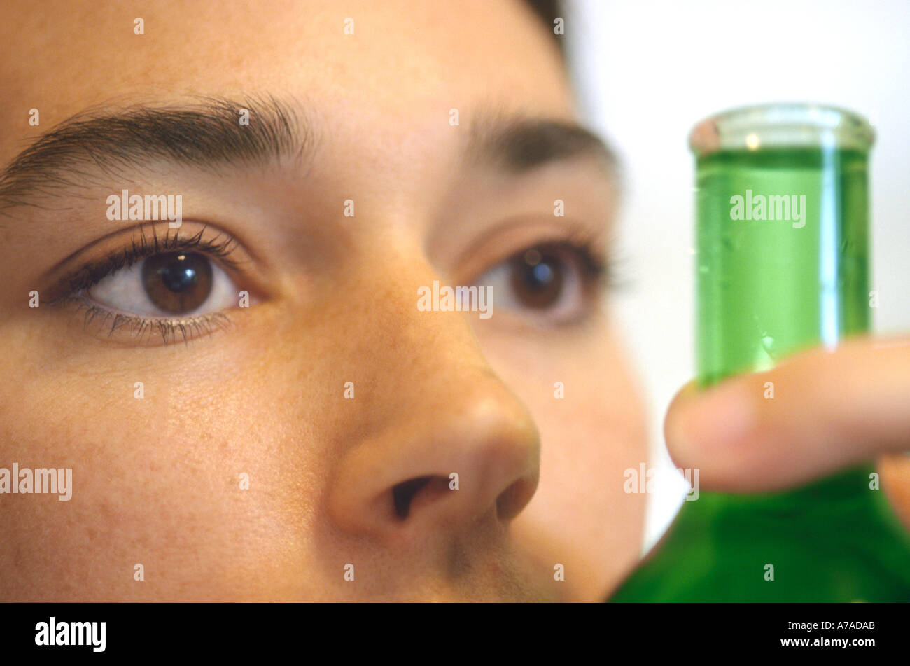 lab technician checking beaker of liquid sample Stock Photo - Alamy
