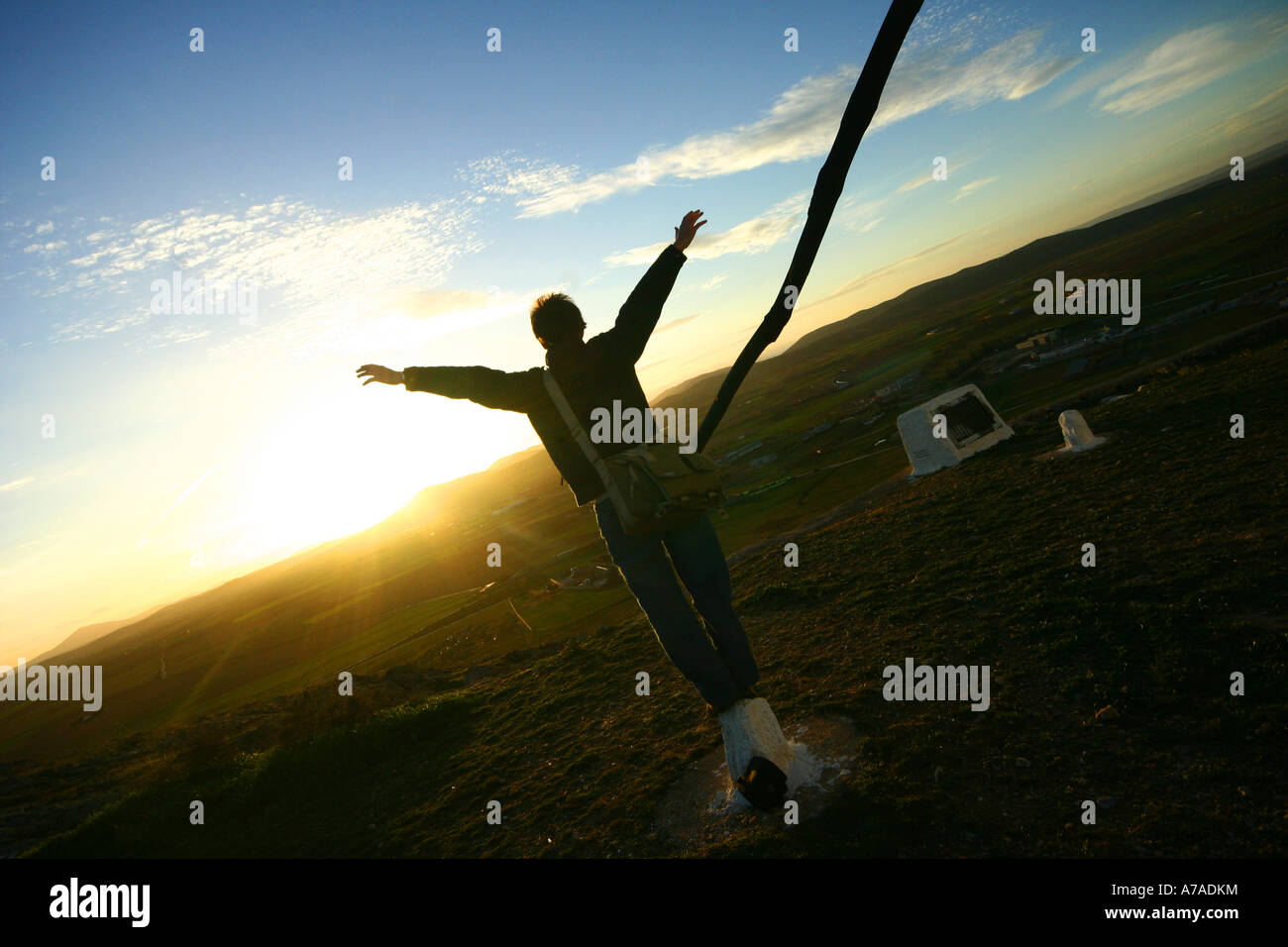 Extremely happy man waving at the setting sun Stock Photo - Alamy