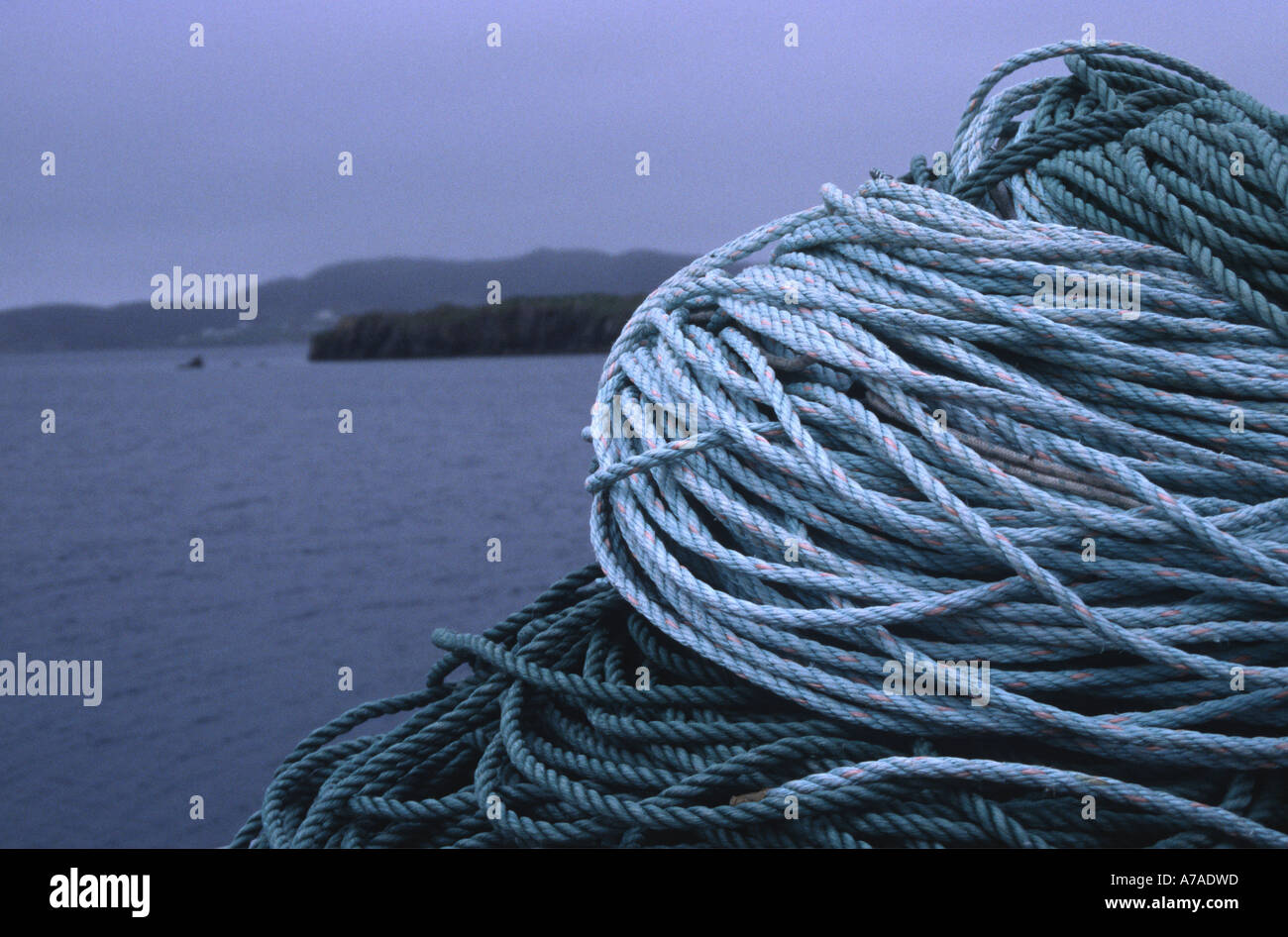 Coiled fishing rope on the dock at a Newfoundland fishing village Stock ...