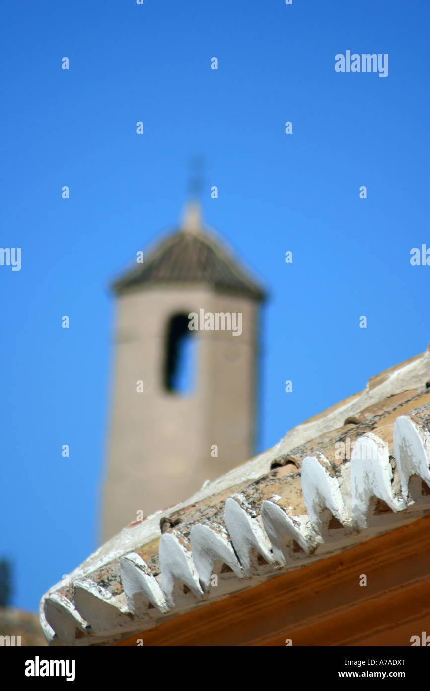 typical Spanish red tile roof and the tower of an old church in the ...
