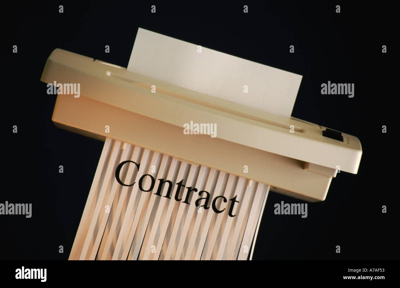 Paper with Contract printed on it going through shredder Stock Photo ...