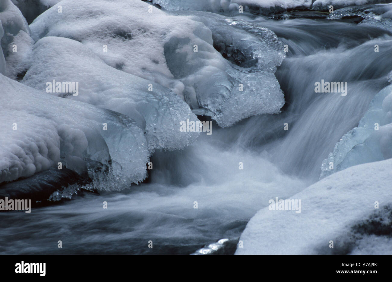 Ice forming at the sides of a stream in early winter in Quebec Stock ...