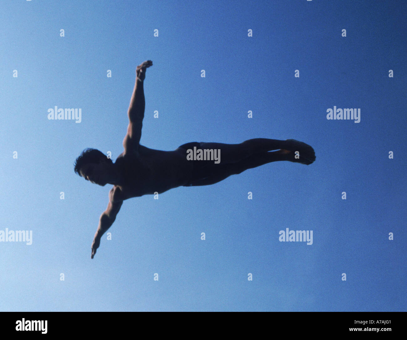 Diver flying off springboard into swimming pool Stock Photo - Alamy