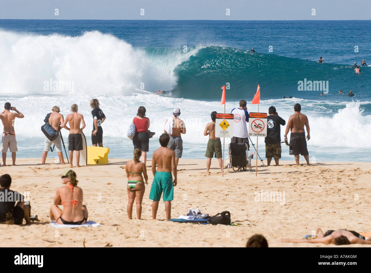 Sightseers on beach watching the surfing action at Pipeline, North ...