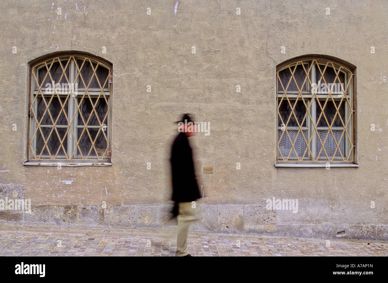 Blurred man walking past a window in Munich, Germany Stock Photo - Alamy