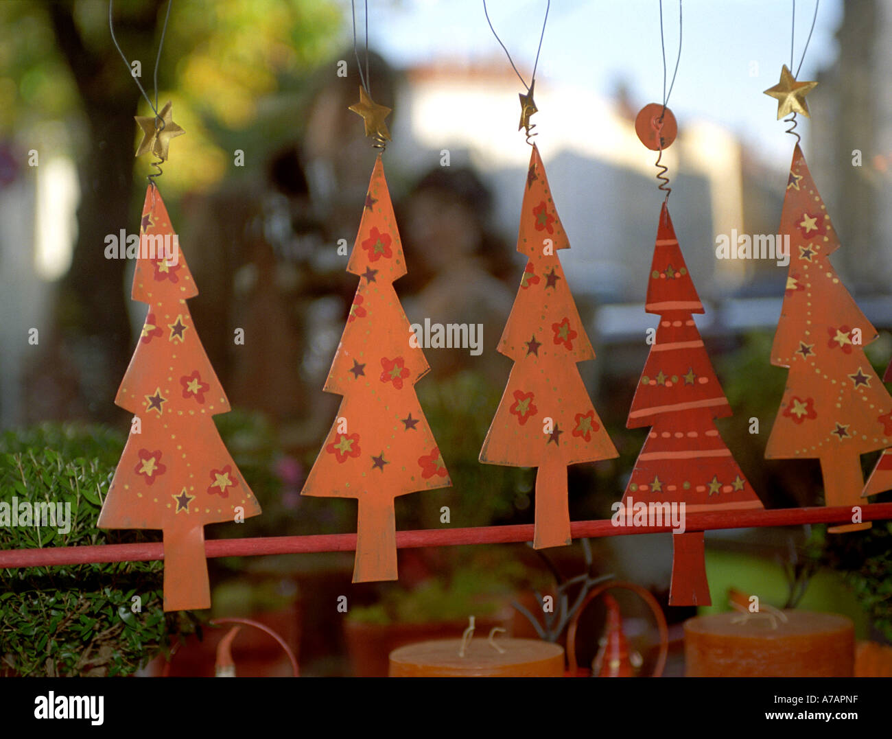 little christmas trees made of paper hanging in shop window Stock Photo ...