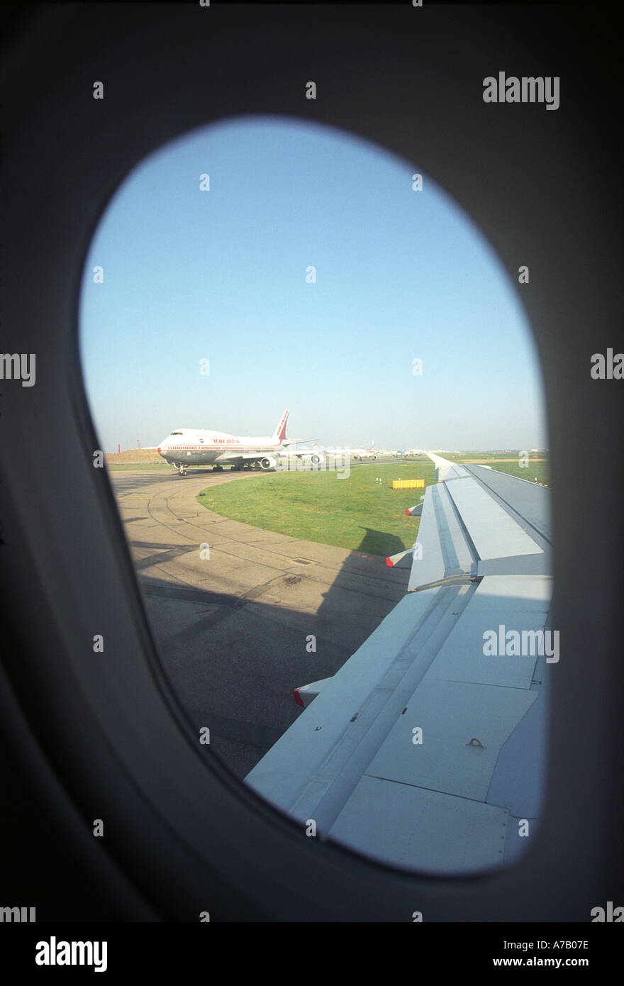 View through an aeroplane window before takeoff showing queue of ...