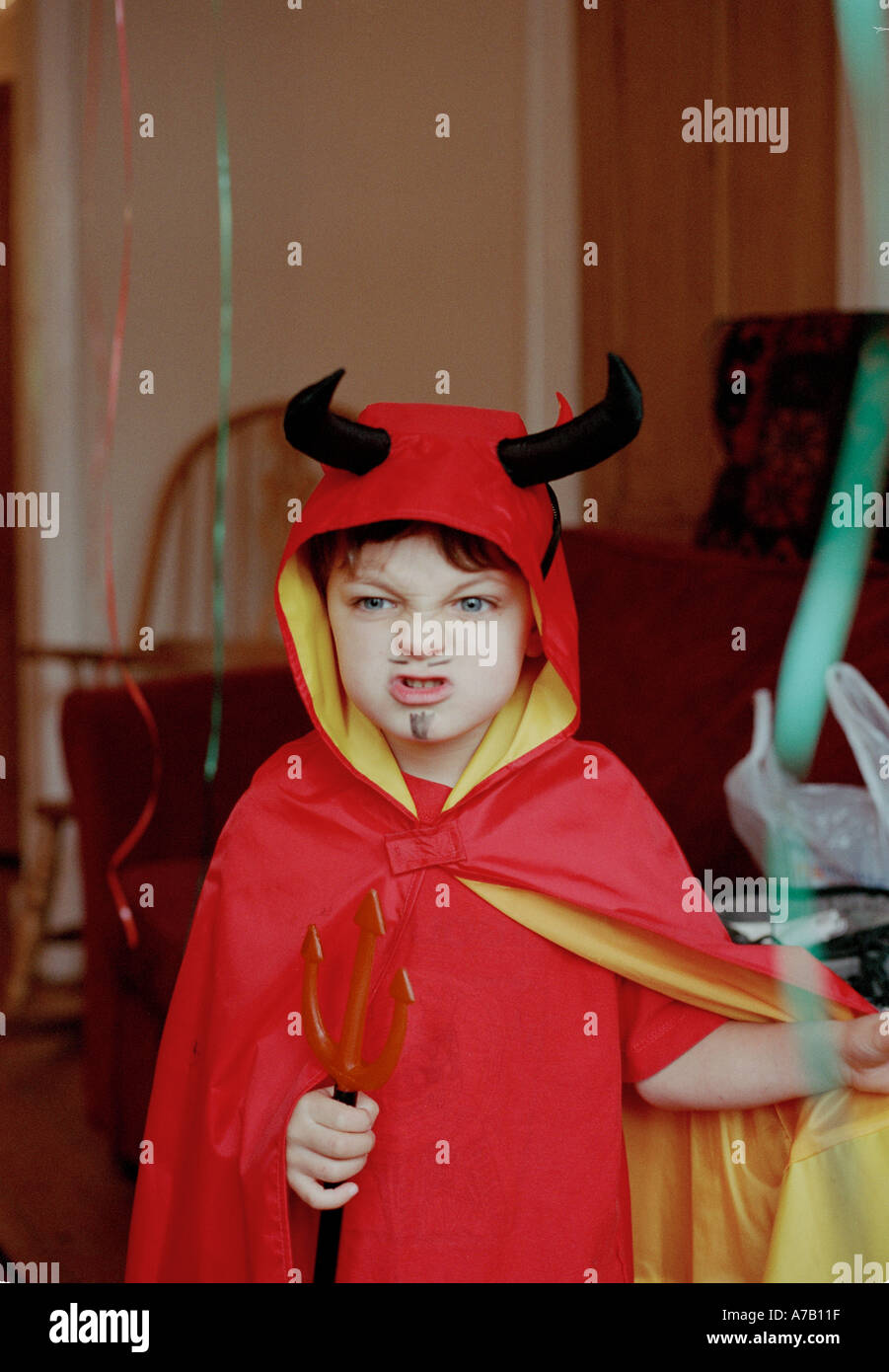 small boy dressed up as the devil with cape and horns Stock Photo - Alamy